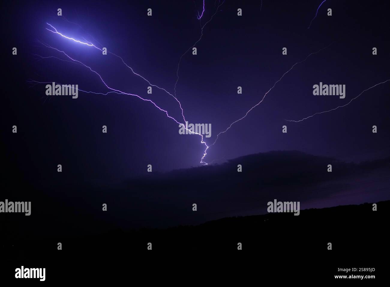 The sky is dark and the lightning bolt is bright and striking. The sky ...
