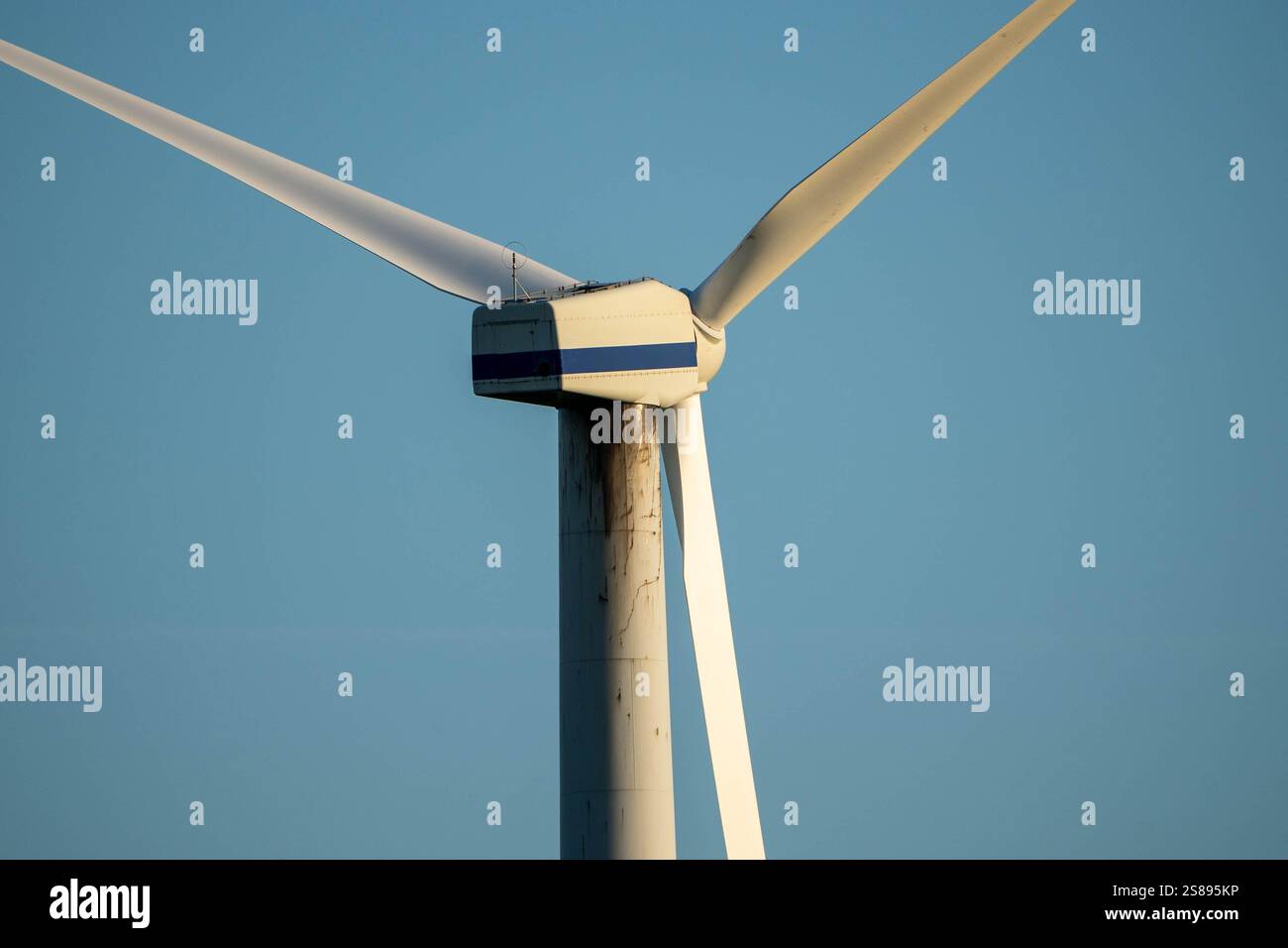 A wind turbine is shown in the sky with a blue and white color scheme ...