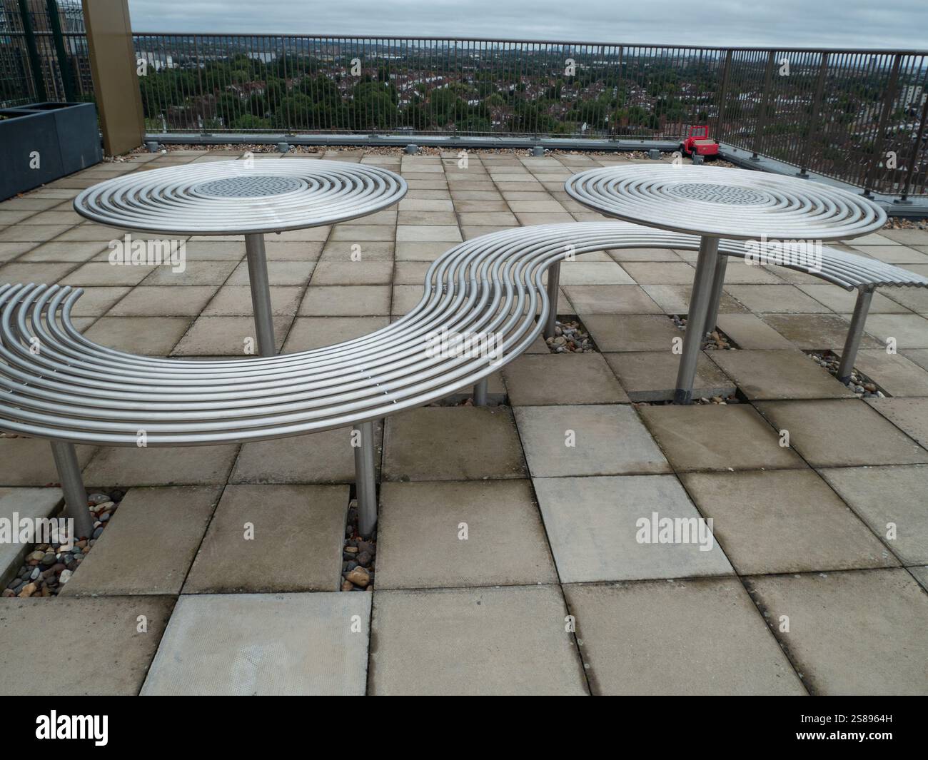 Metal benches and tables on a rooftop patio Stock Photo - Alamy