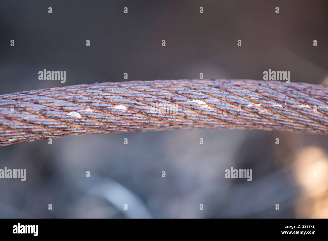 A rusty chain is shown in a close up. The chain is old and worn, with ...
