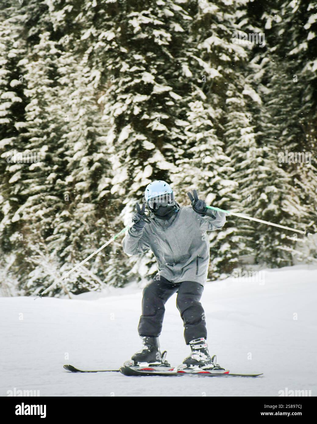 Close up Cute brave beginner boy male skier ski by forest on slope in ...