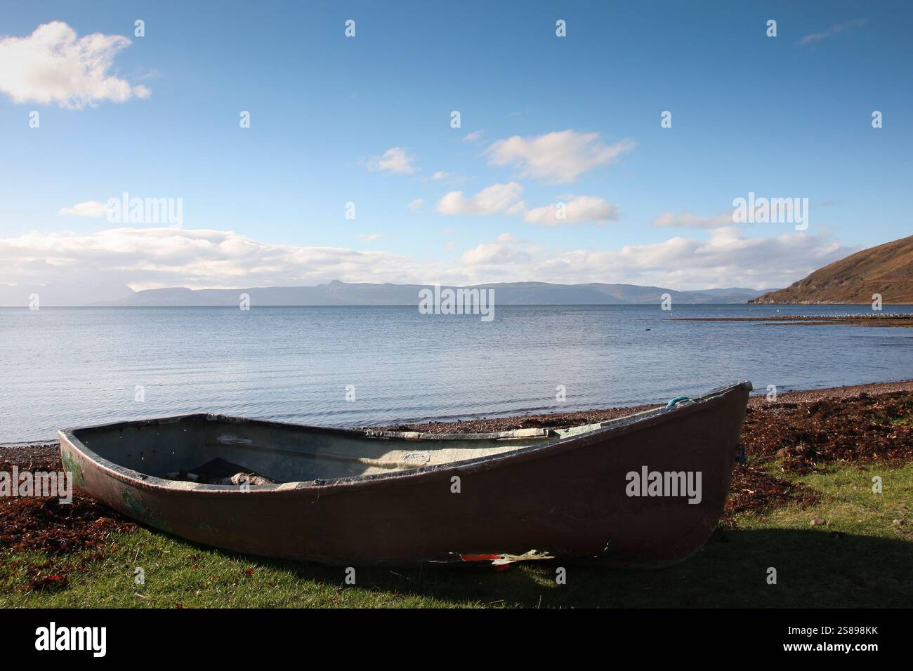 Old rowing boat on shore on West Coast of Scotland Stock Photo - Alamy