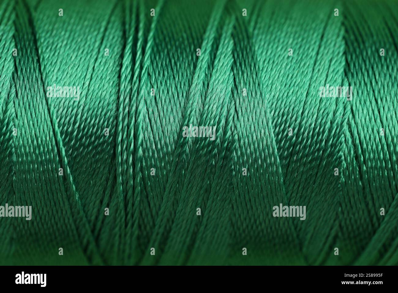 Spool of green sewing thread as background, closeup Stock Photo - Alamy