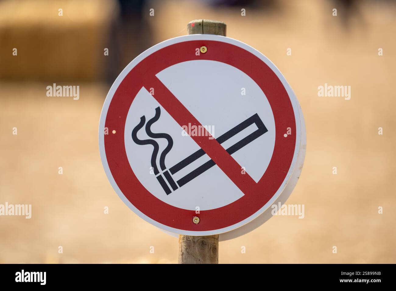 A no smoking sign is on a post. The sign is red and white Stock Photo ...
