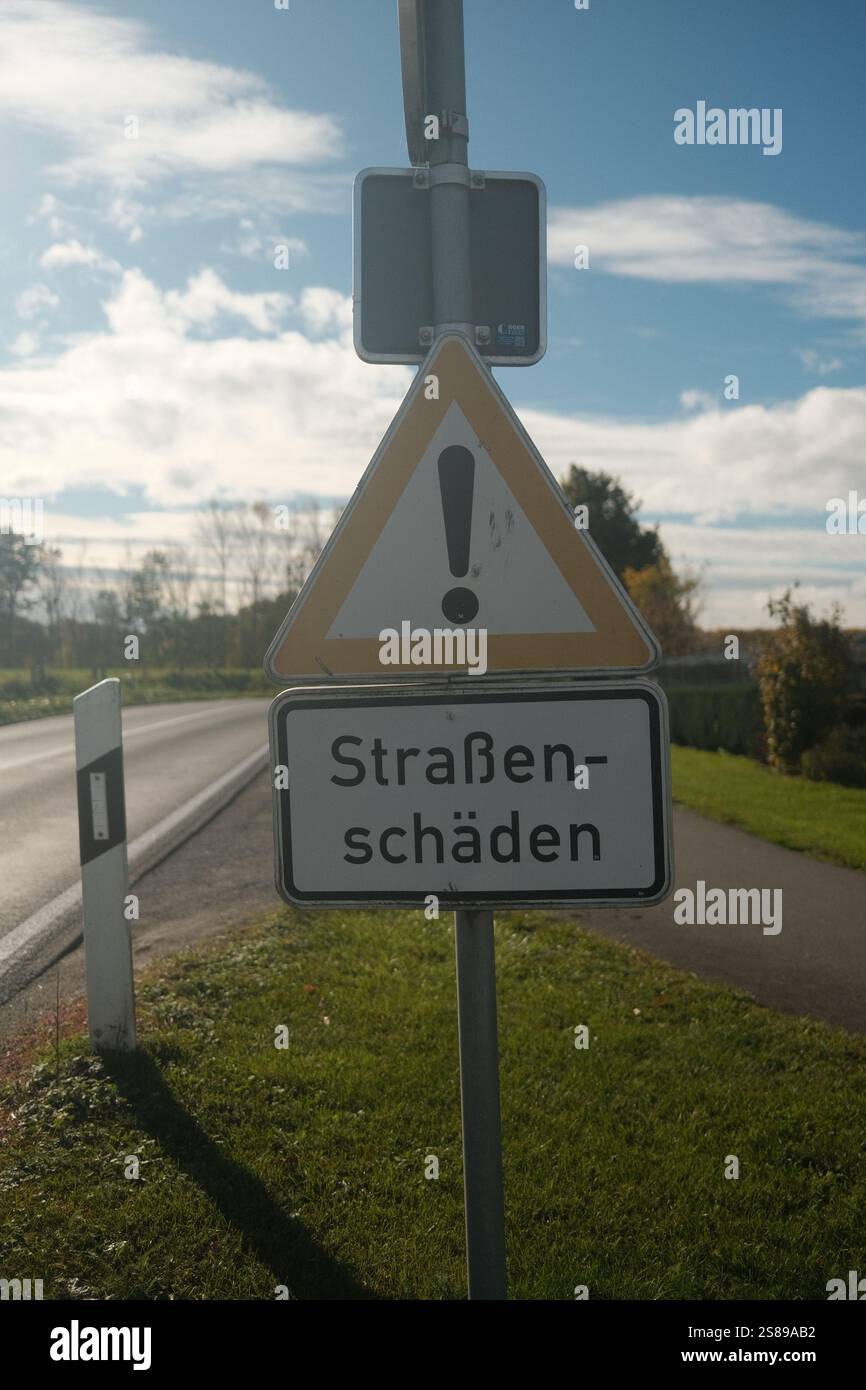 A warning sign with a red triangle and the word "Strafen-Schaden ...