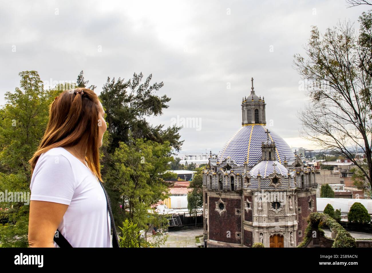 Female tourist visiting the Basilica of Guadalupe complex and the ...