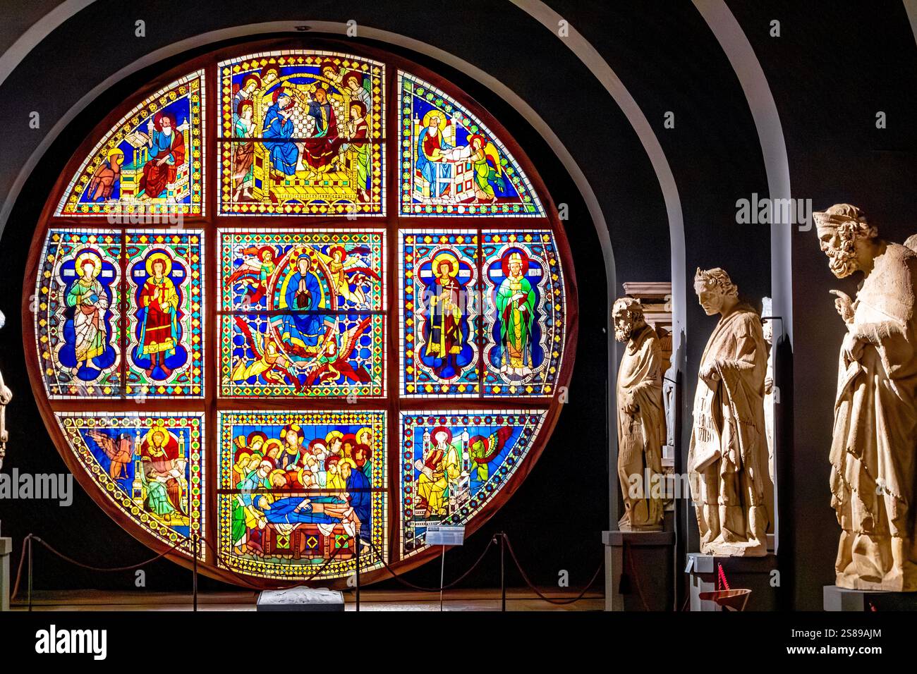 The great stained glass window by Ducco, surrounded by marble statues inside the Museo dell ...