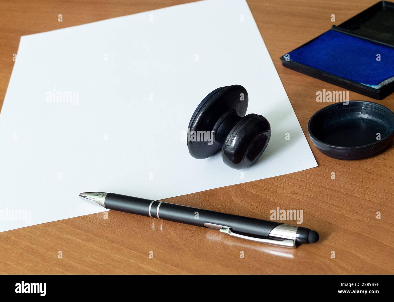 Sheet of paper pen and stamp dejat on the desk Corporate Document ...