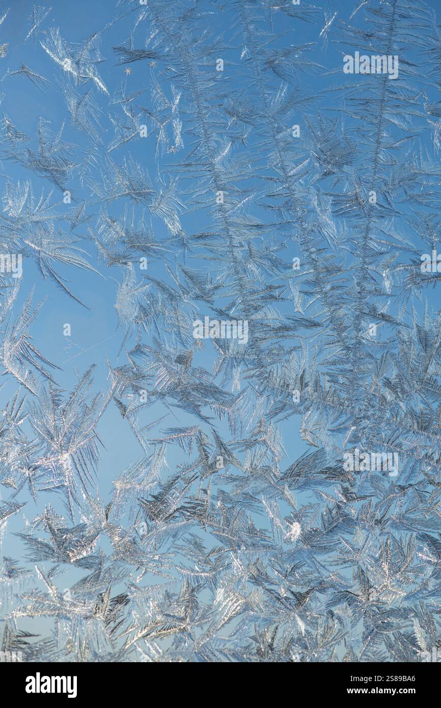 Winter frost on windows with sun pouring in and illuminating the ice ...