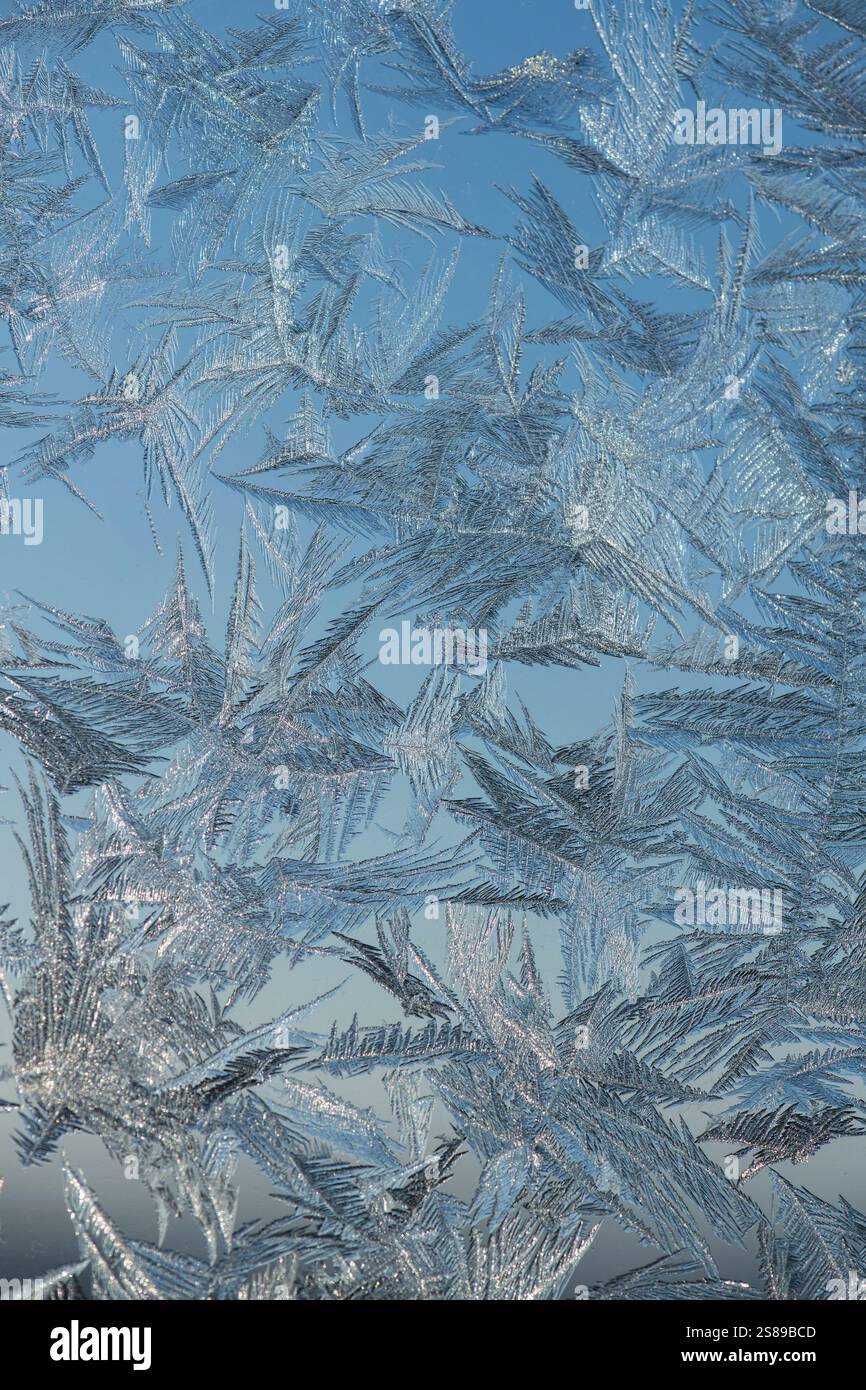 Winter frost on windows with sun pouring in and illuminating the ice ...