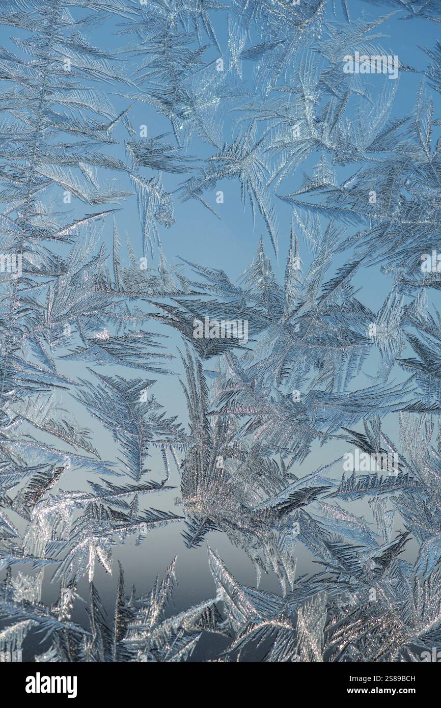 Winter frost on windows with sun pouring in and illuminating the ice ...