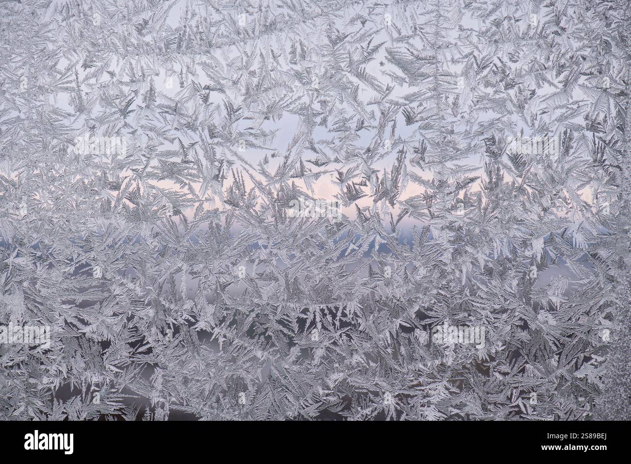 Winter frost on windows with sun pouring in and illuminating the ice ...