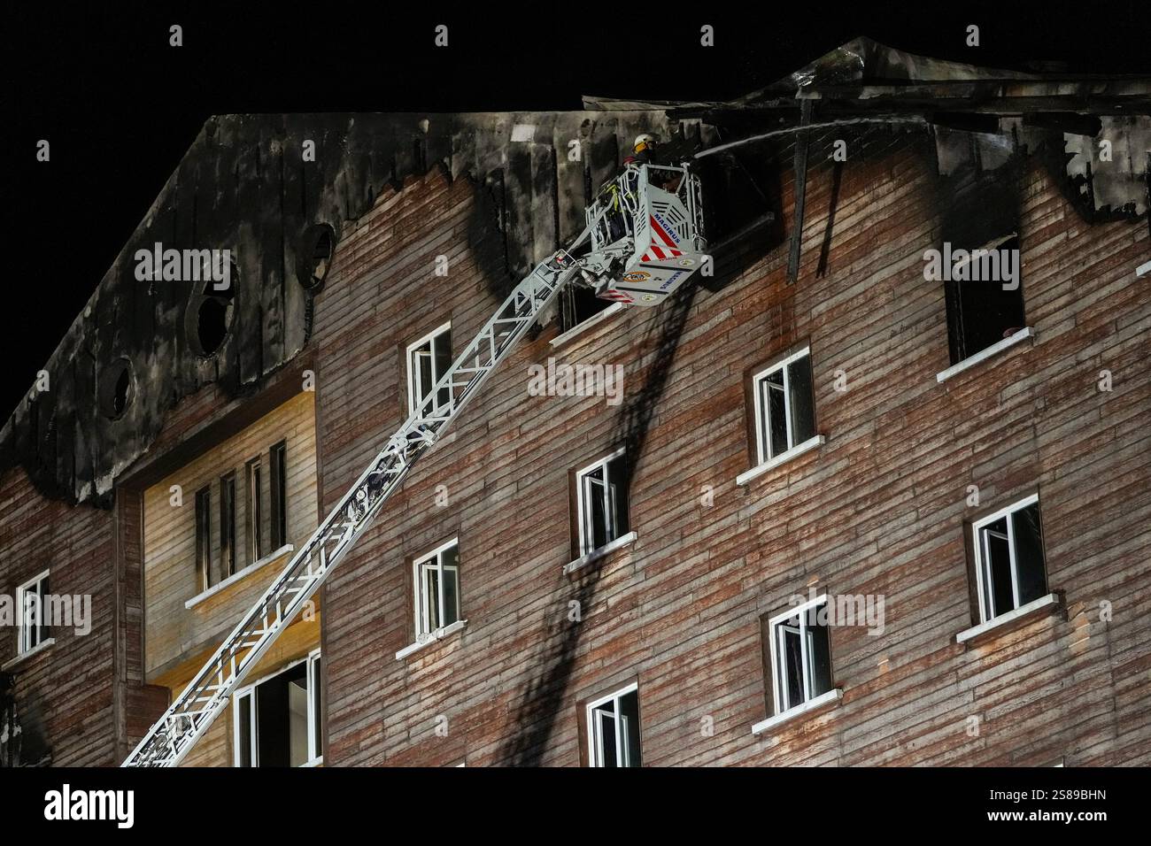 Firefighters work on the aftermath of a fire that broke out at a hotel ...