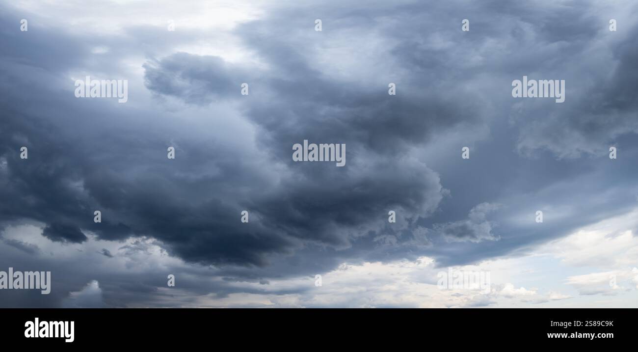 Ominous dark storm clouds are gathering in the sky, creating a dramatic ...
