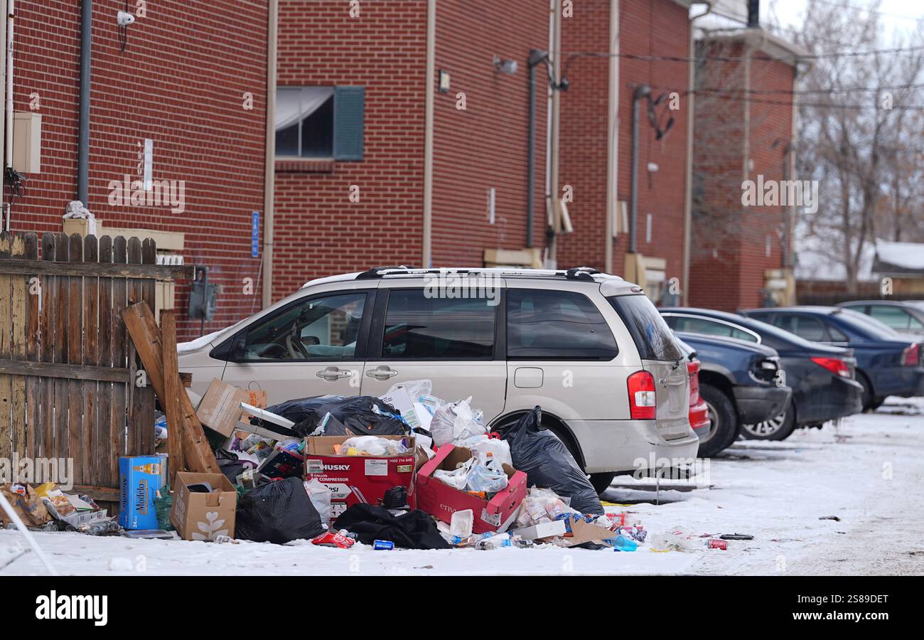 Garbage piles up outside one of the apartment buildings at the center ...