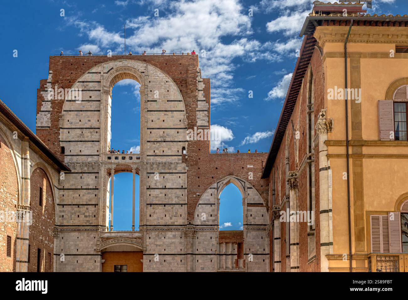 People at the top of The Facciatone of Siena,the remains of the New ...
