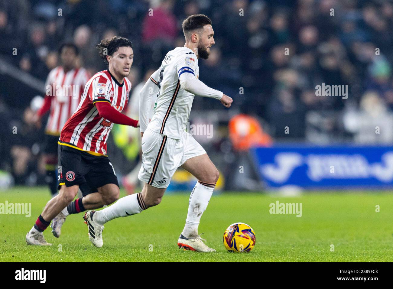 Swansea, UK. 21st Jan, 2025. Matt Grimes of Swansea City (R) in action ...