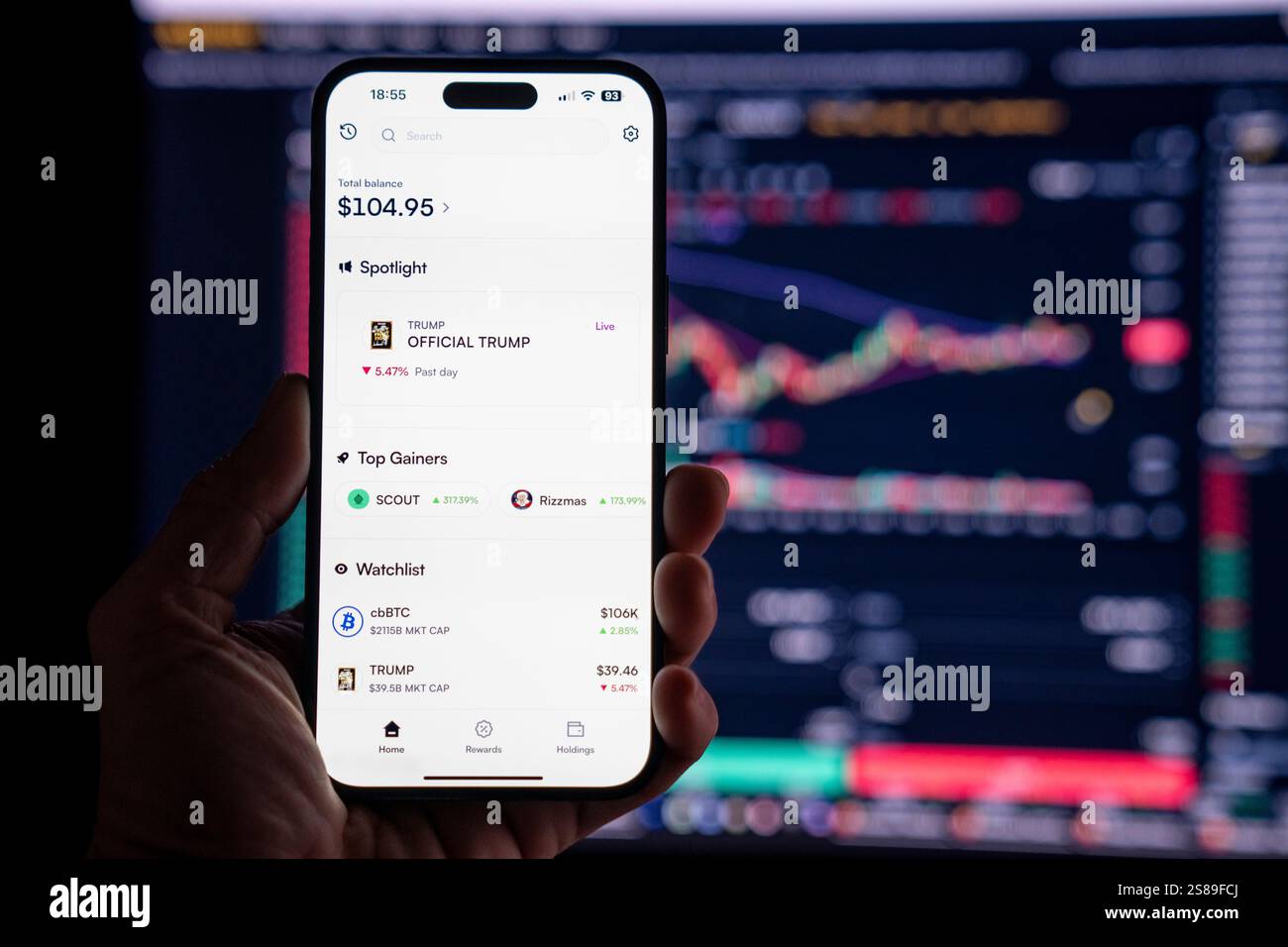 Man holding a phone displaying the OFFICIAL TRUMP meme, with a blurred ...