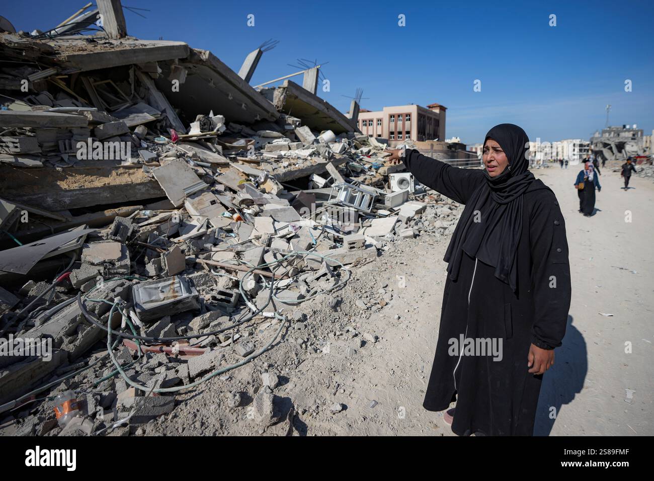 Manual Aslim reacts next to the ruins of her destroyed home, days after ...