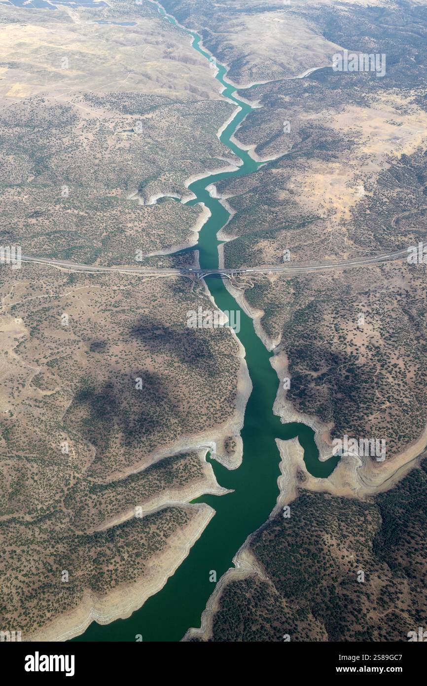 Aerial view of the Tagus river and a bridge before the Embalse de José ...