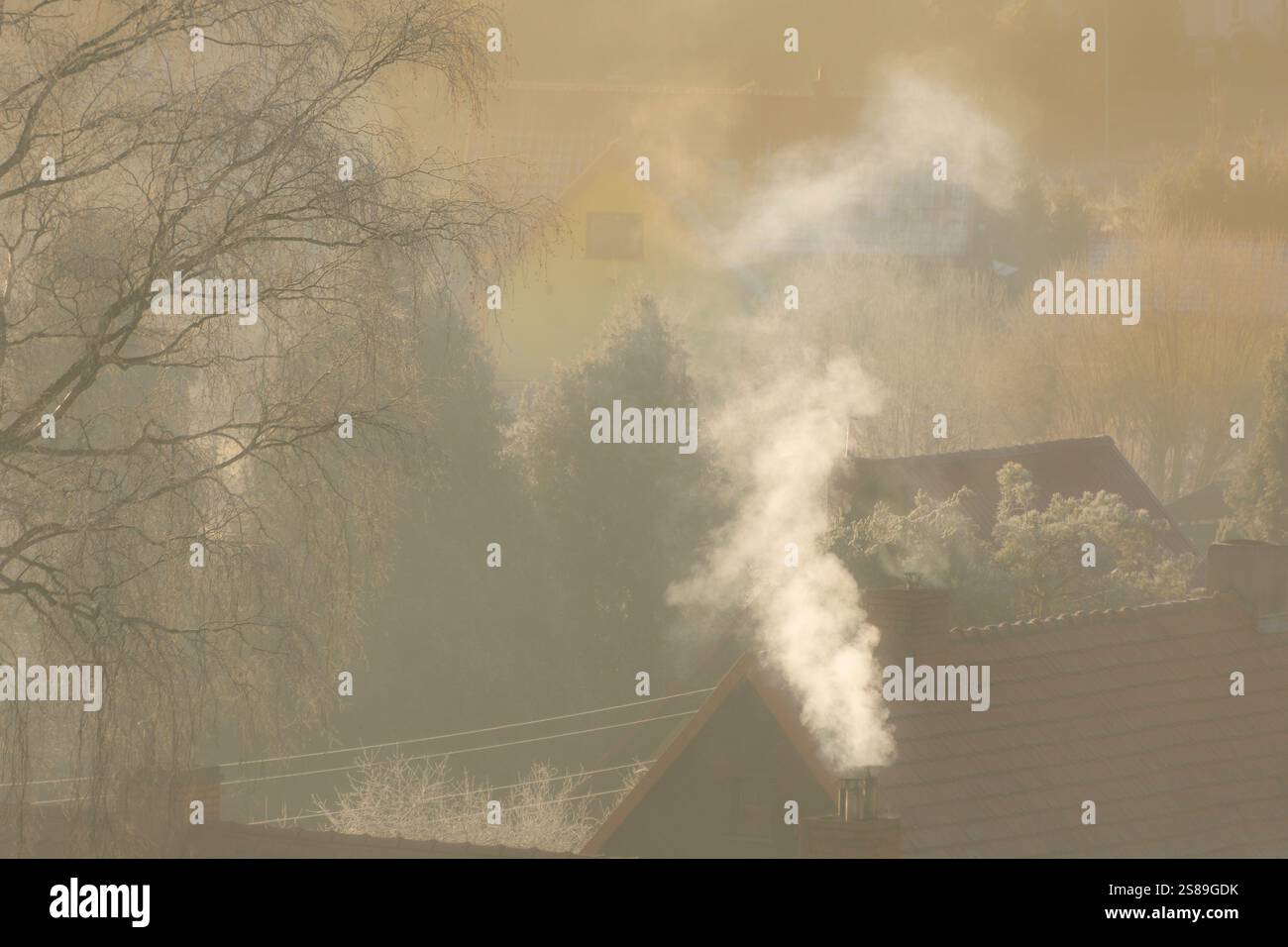 Smoke above house at winter dawn Stock Photo - Alamy