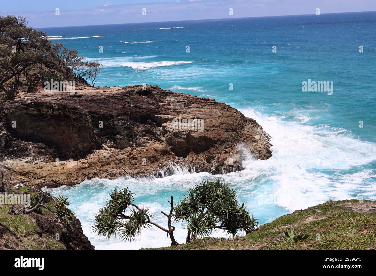 blue ocean waves breaking on rocky outcrop shore Stock Photo - Alamy