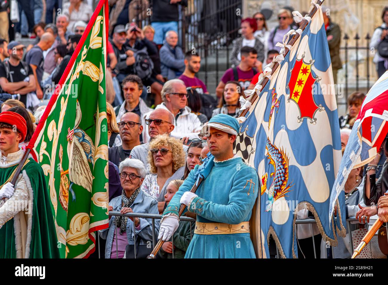 Flag bearers holding the flags of the Onda or Wave Contrada and Oca ...