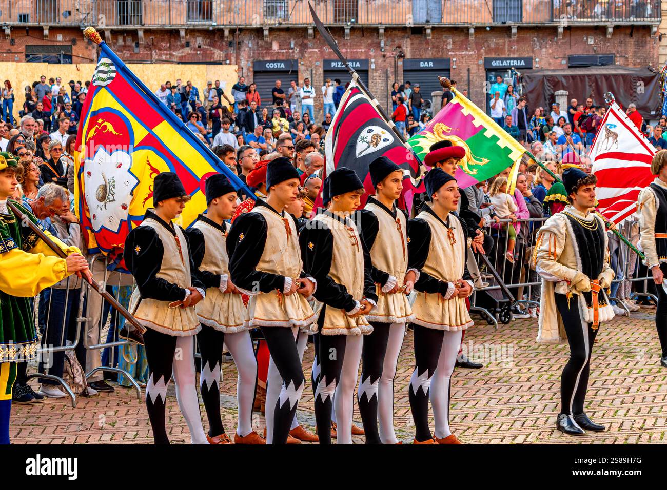 Traditional Contrada costumes and flags at a Contrada Parade in Siena ...