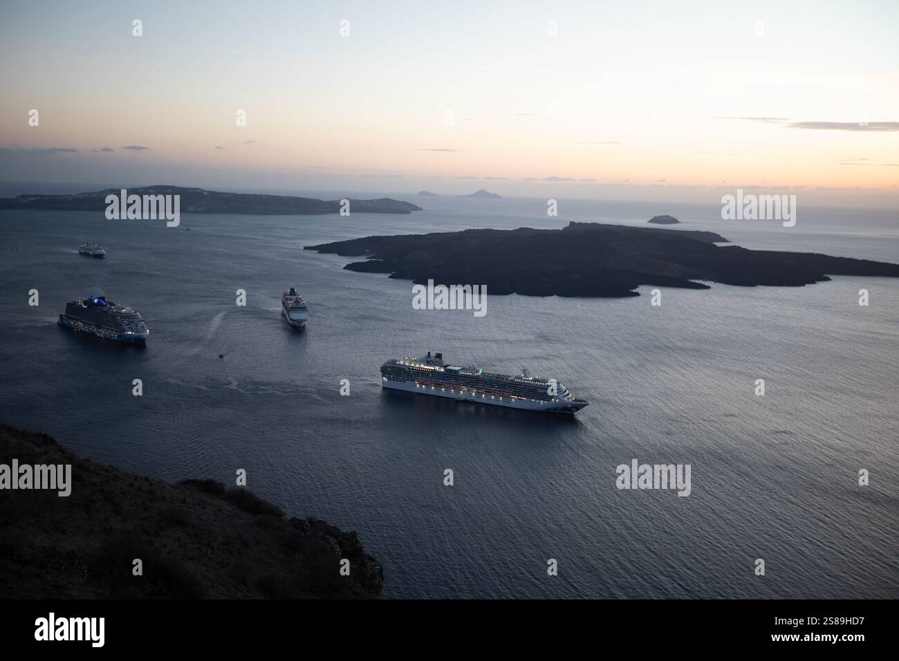 Cruise ships sail past islands at sunset Stock Photo - Alamy
