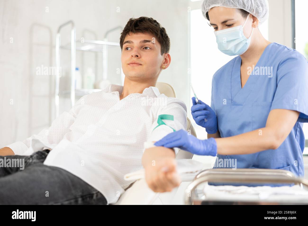 Intravenously injection male patient Stock Photo - Alamy