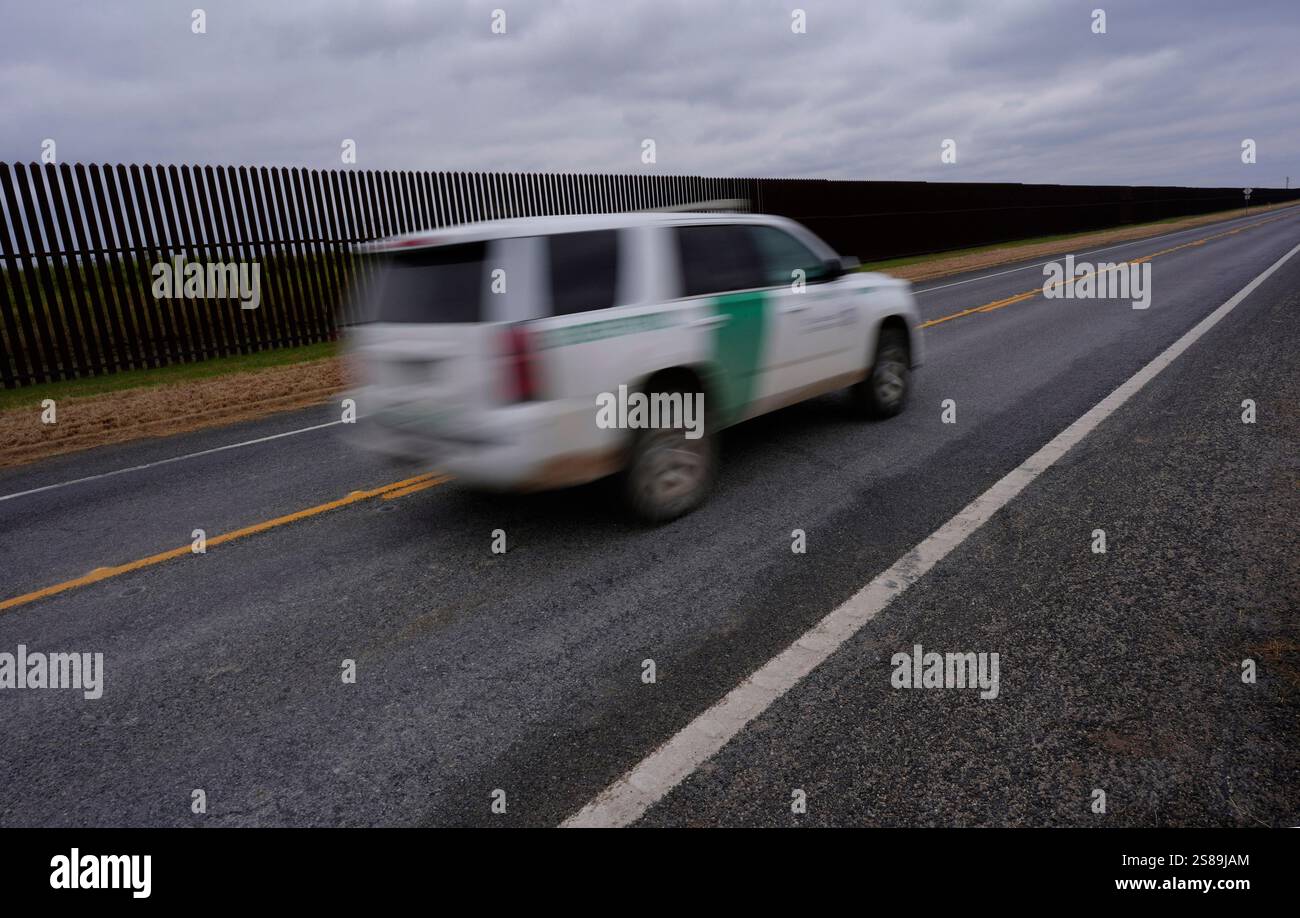A Border Patrol Agent moves along a stretch of boarder wall, Tuesday ...