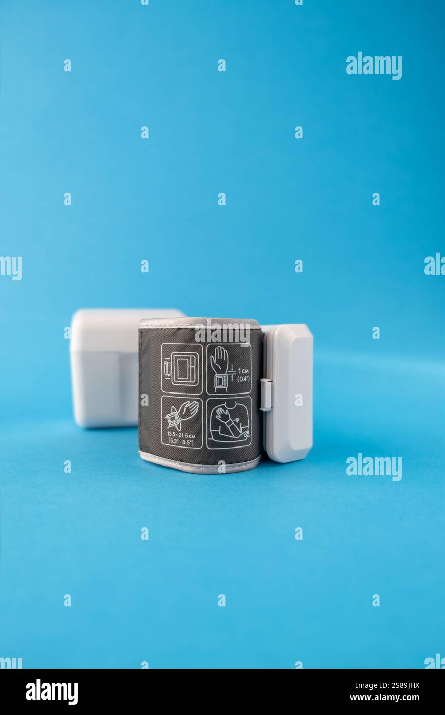Blood Pressure Monitor Cuff With Instructions For Use On A Blue