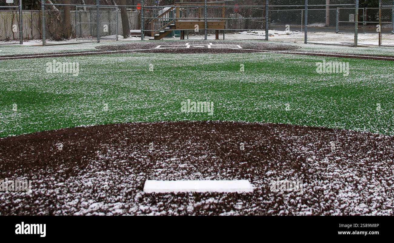 A drone captures a fresh artificial turf baseball field blanketed in a ...