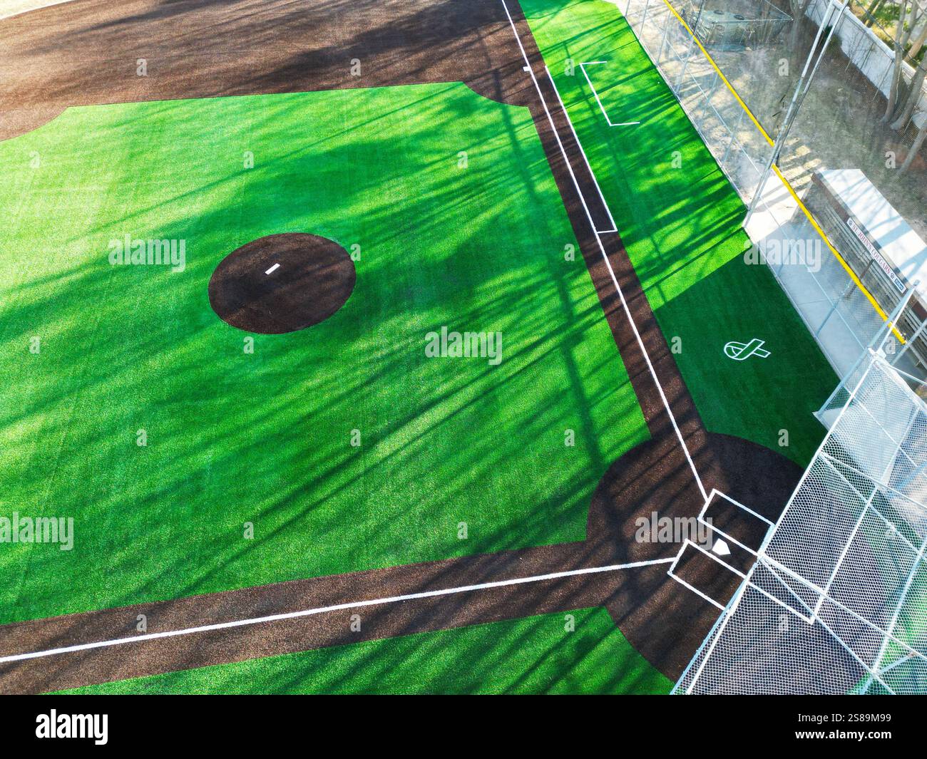 Aerial view of a freshly installed artificial turf baseball field with ...