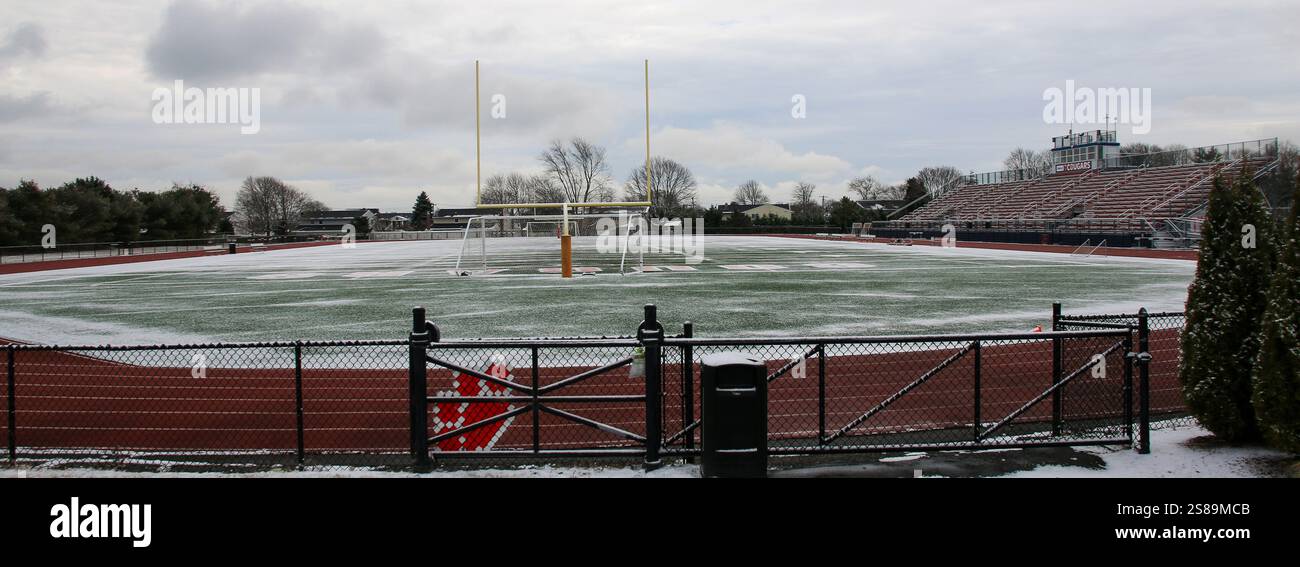 An empty soccer field is covered in snow, complete with goalposts for ...