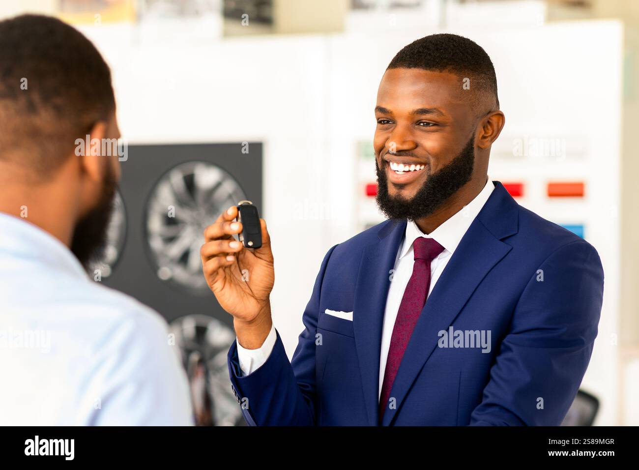 Black Salesman And Male Customer Shaking Hands After Deal In Dealership ...