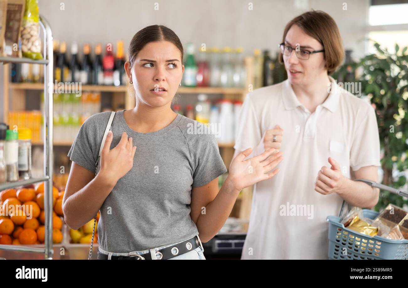 In shop guy stands behind wife, hurling abuse and indignation at her ...