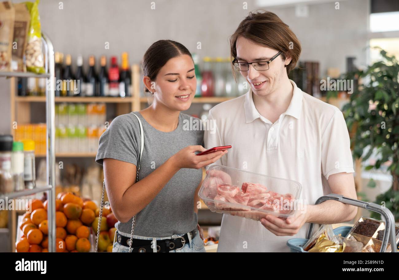 In shop youth spouses scan QR code and take reading raw pork tenderloin ...