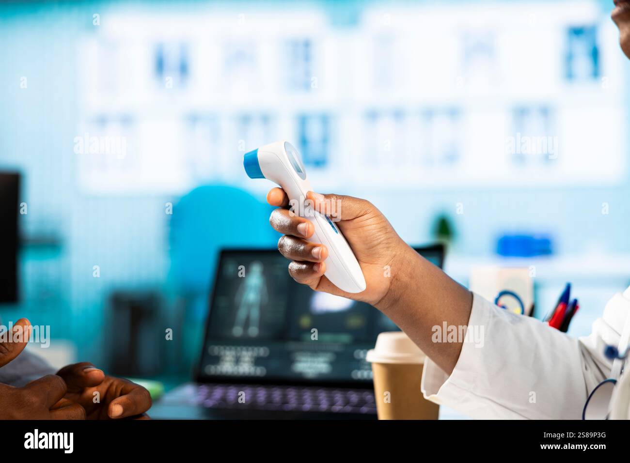 Medic measuring the temperature during checkup appointment at doctor ...