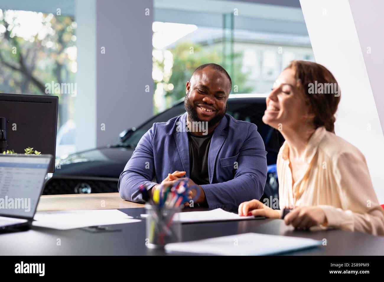 Salesman closing deal with smiling satisfied customers after ...