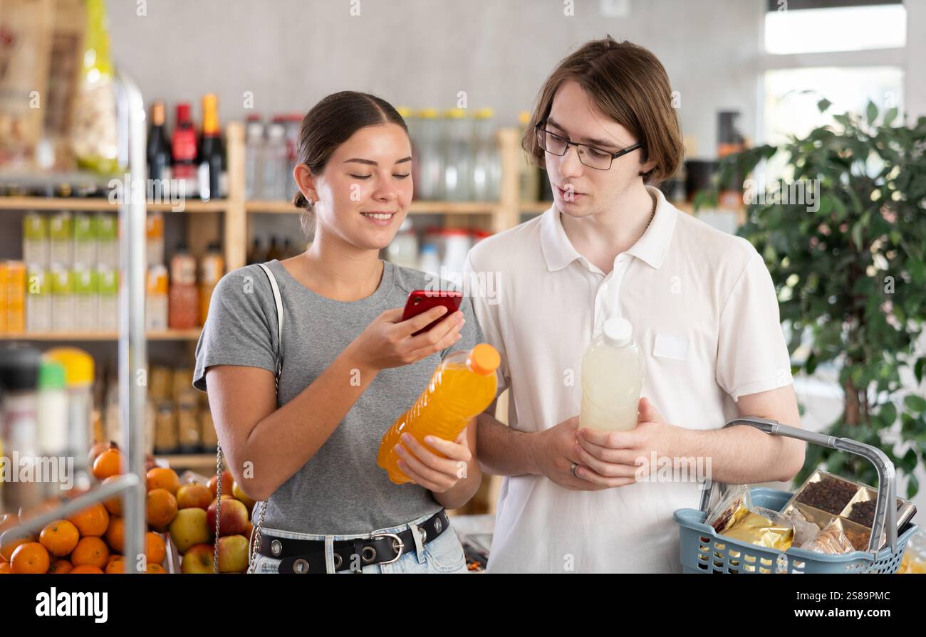 Woman and man scanning drinks Stock Photo - Alamy