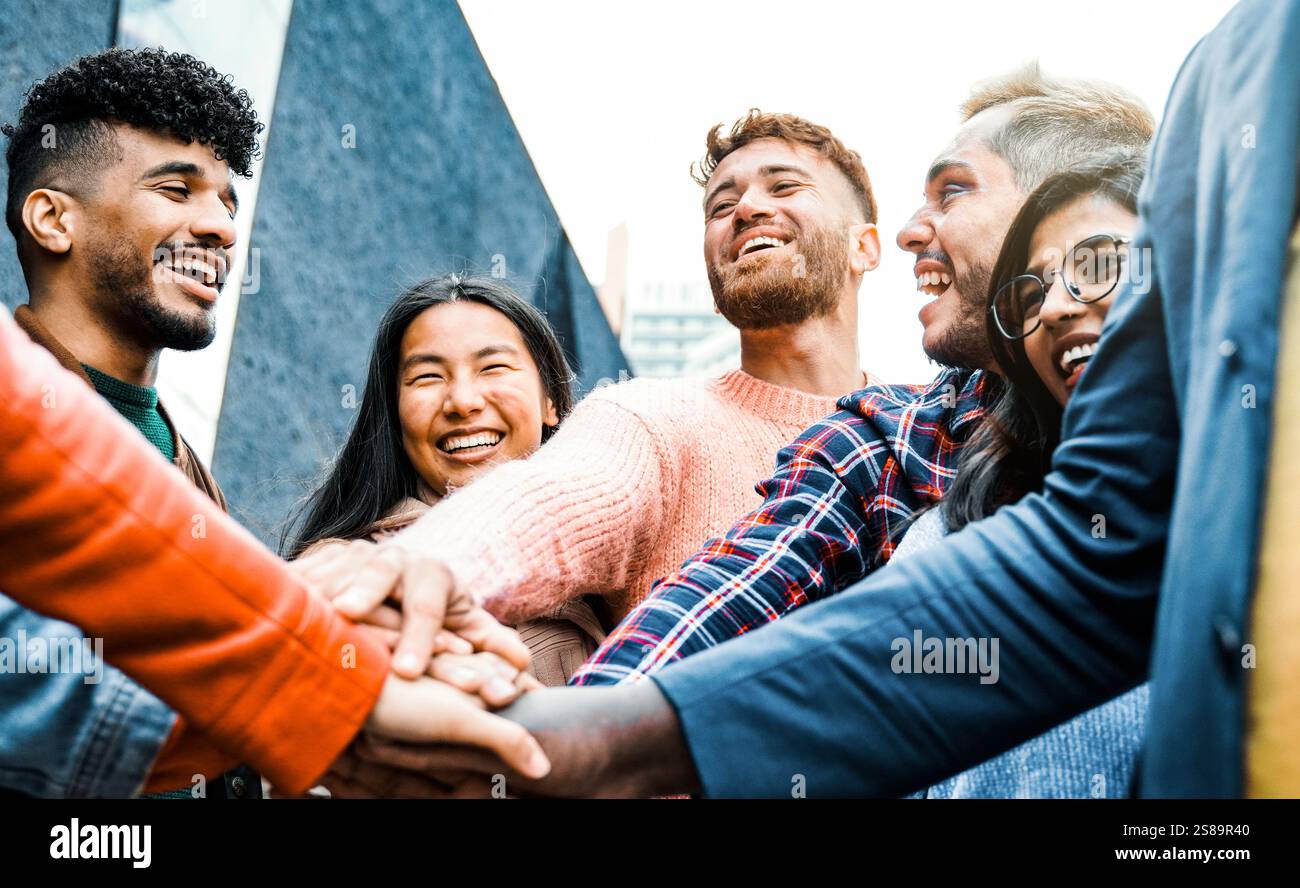 Group of people stacking hands, celebrating together. Diverse friends ...