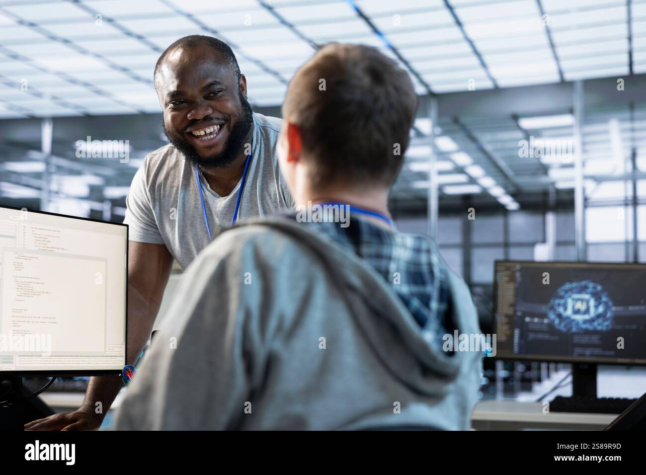Engineer having fun with colleague at work in data center establishment ...