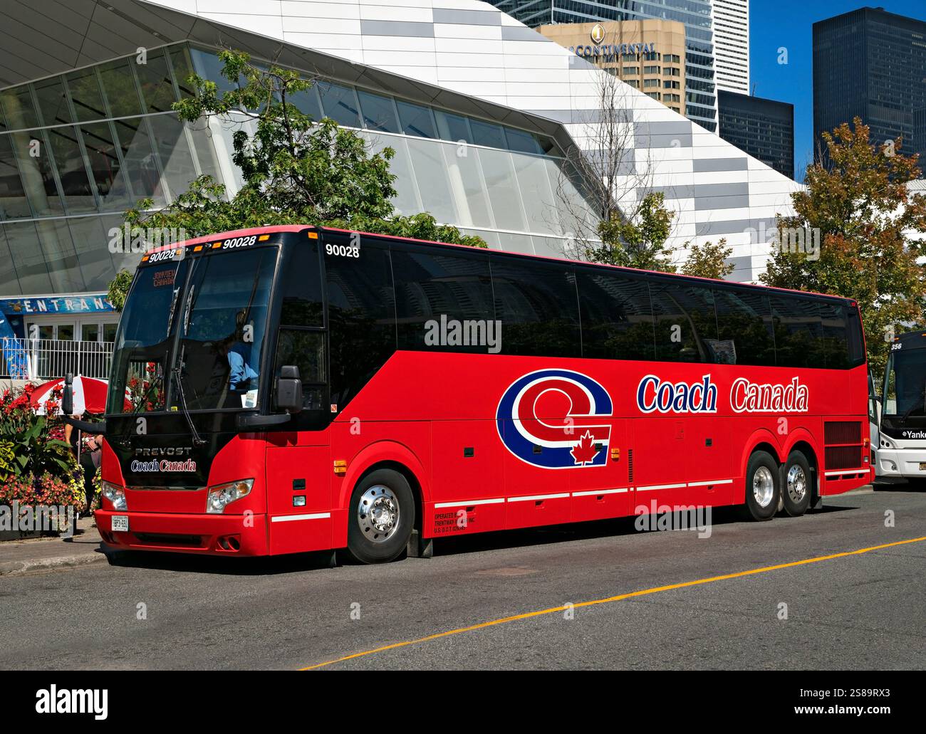 Toronto Canada / A Coach Canada Bus transports tourists to the CN Tower and Ripley's Aquarium ...