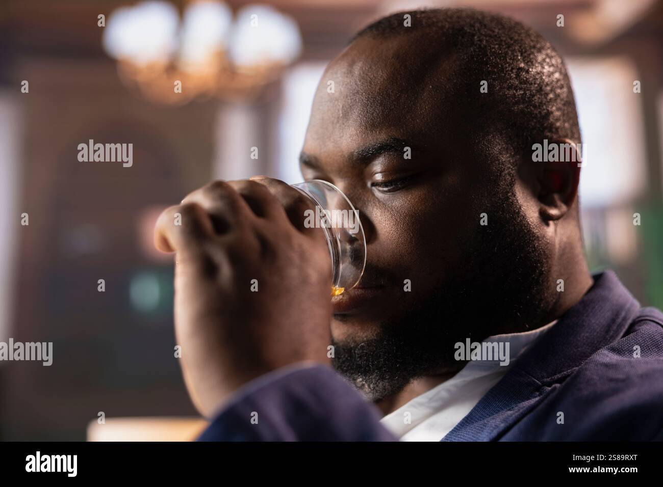 Upper class billionaire drinking whiskey at the elite social club ...