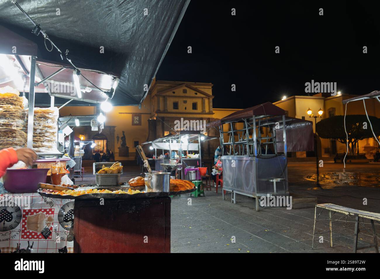 At night, the vibrant market near Santuario y Exconvento de la Santa ...