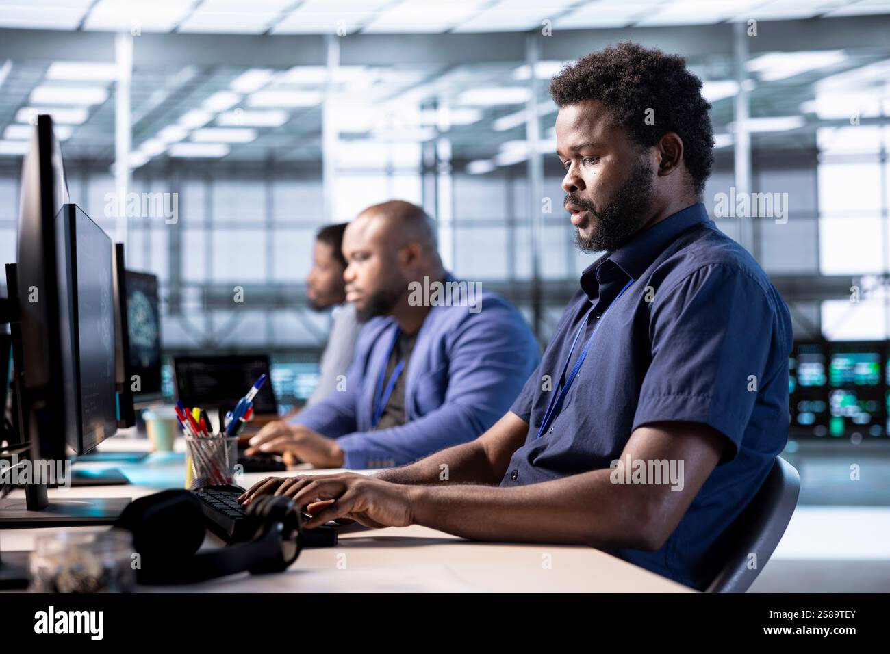 Cybersecurity division employee monitoring security incidents affecting ...