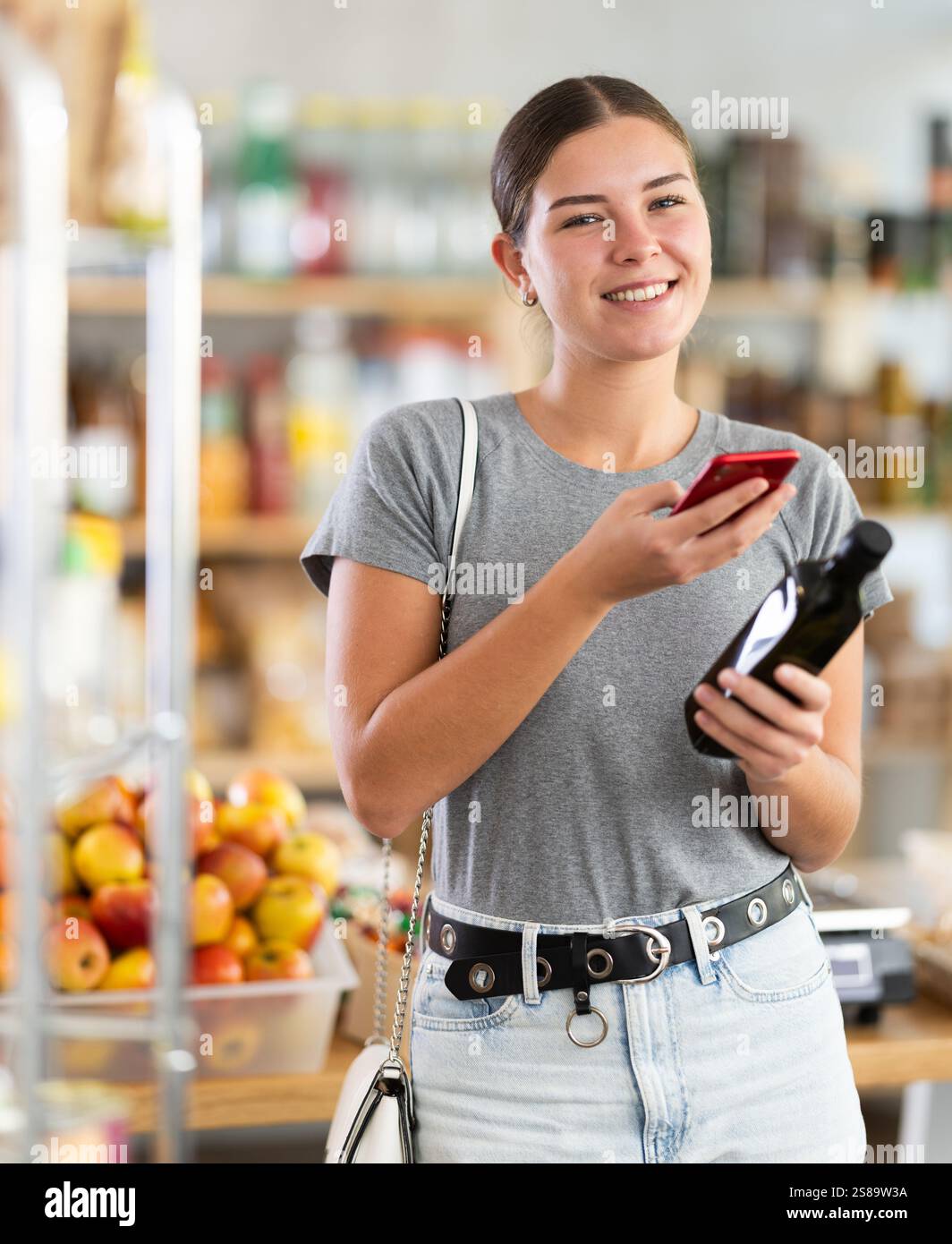 Woman scanning a bottle of olive oil Stock Photo - Alamy