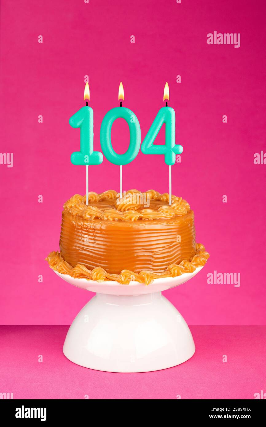 Birthday cake with number 104 candle - Anniversary card on a pink ...