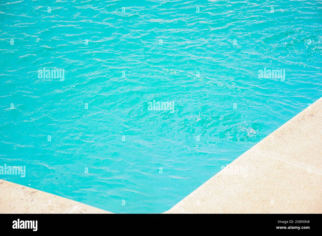 edge of a swimming pool made of white stone, summer concept background ...